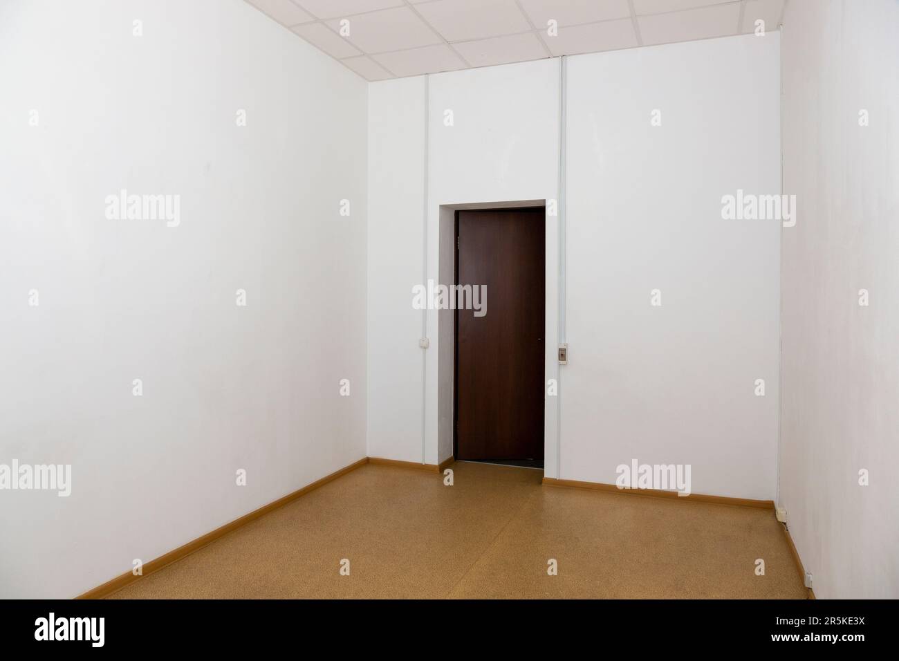 Interior of an empty room with a closed door Stock Photo - Alamy