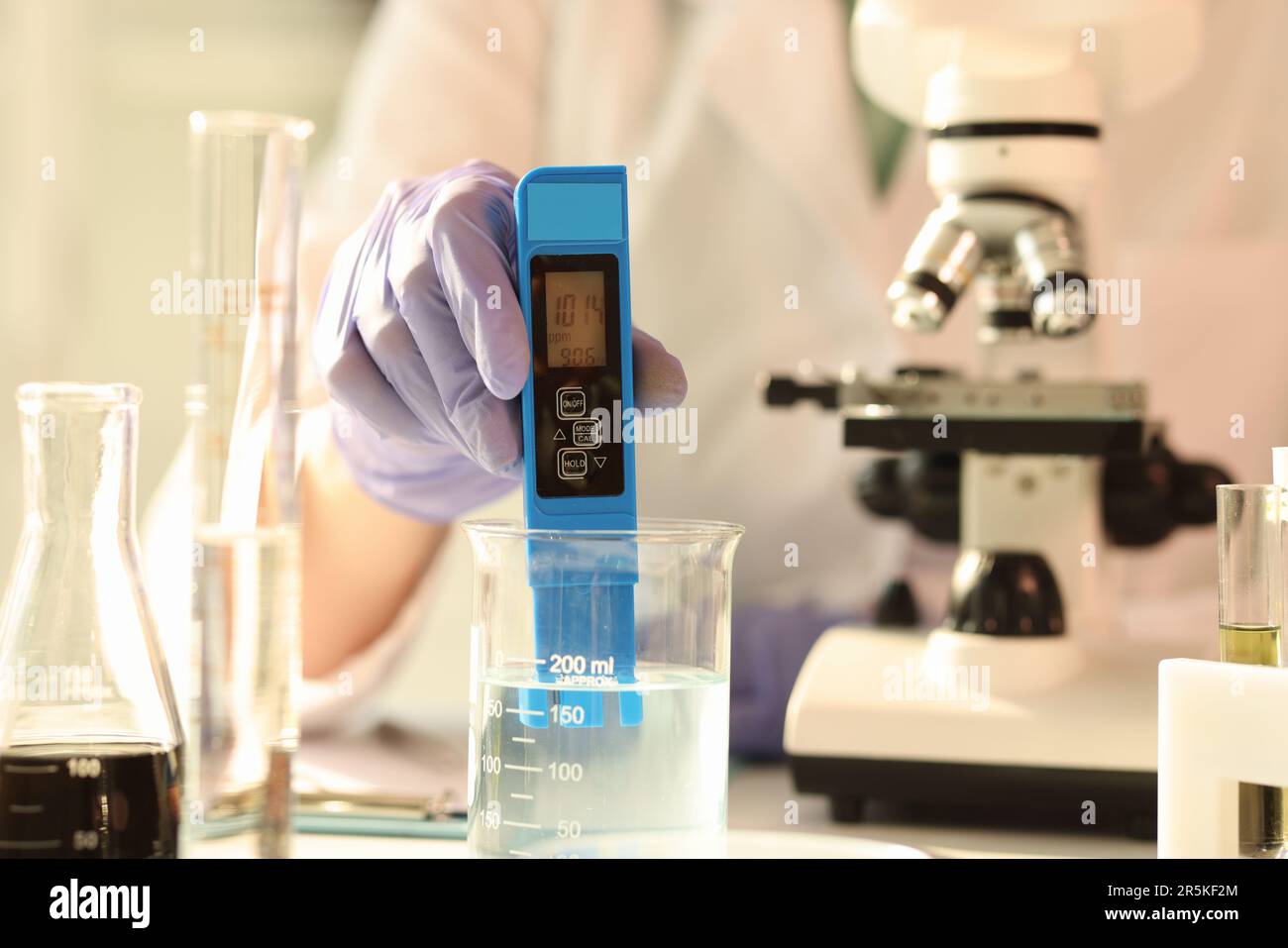 Female scientist checks liquid device hi-res stock photography and ...