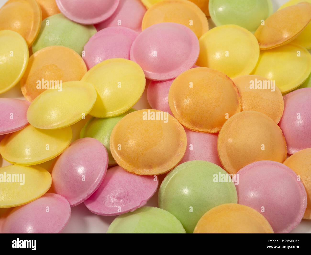 Sweet candies in the shape of a UFO in different colors. Flying saucers ...
