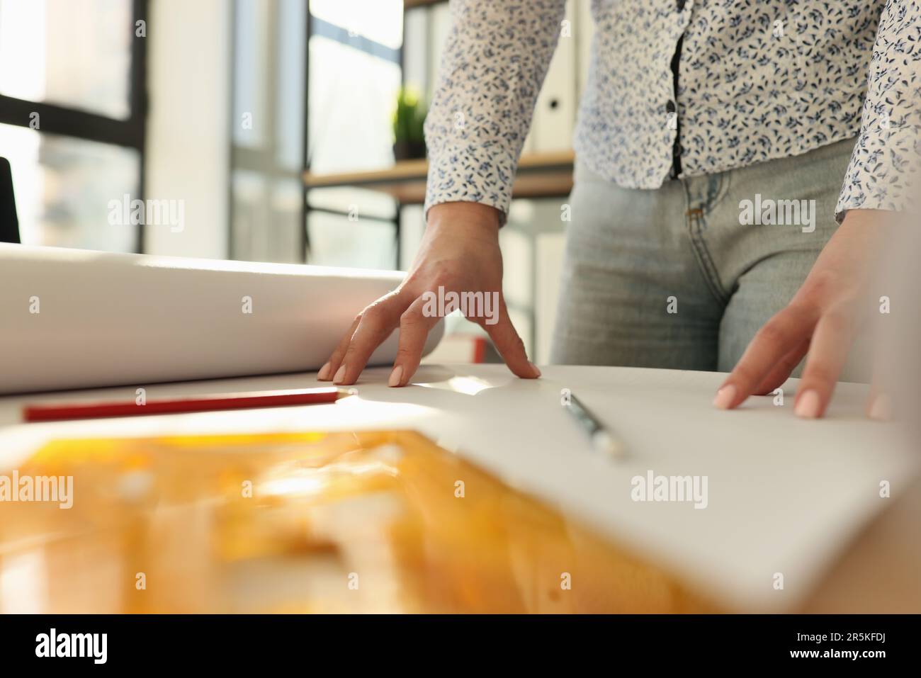 Female architect unrolls large paper hi-res stock photography and ...