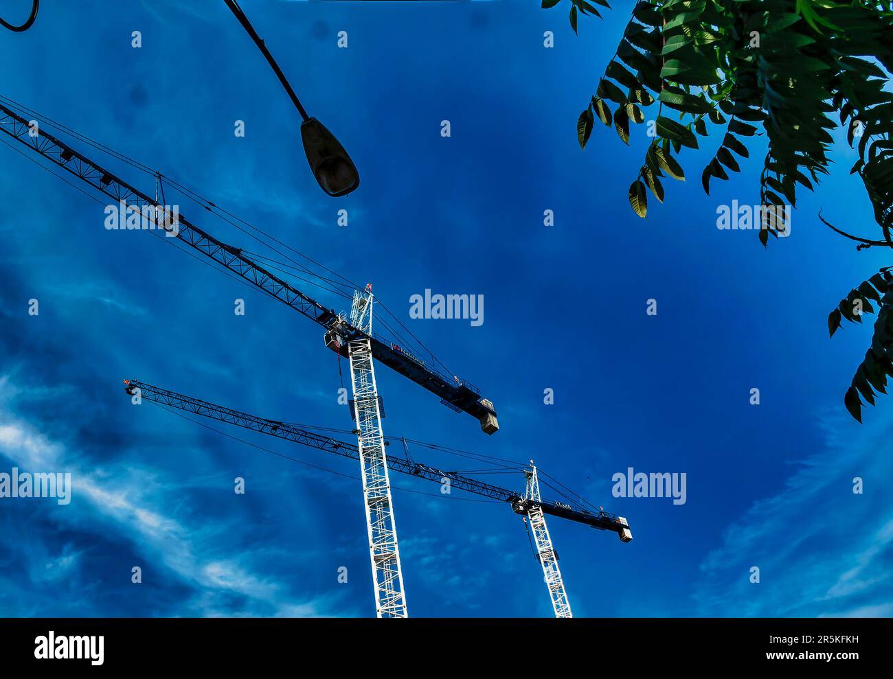 Working cranes in a beautiful sky Stock Photo - Alamy