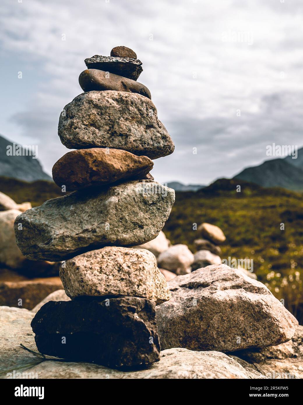 A trail winds through the Scottish Highlands, marked by a pile of rocks ...
