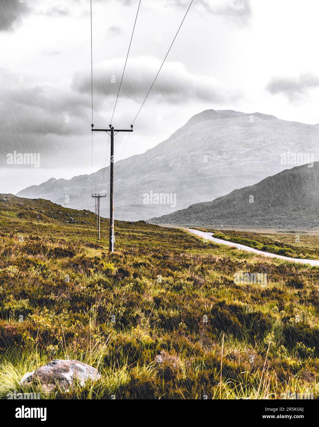 A scenic road winds through the Scottish Highlands, flanked by majestic ...