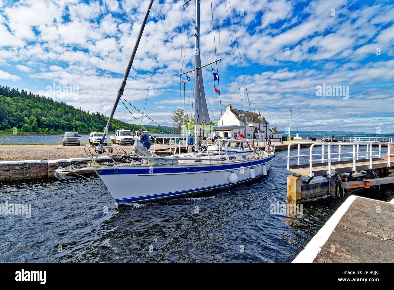Inverness Scotland blue sky and a yacht in early summer passing through ...