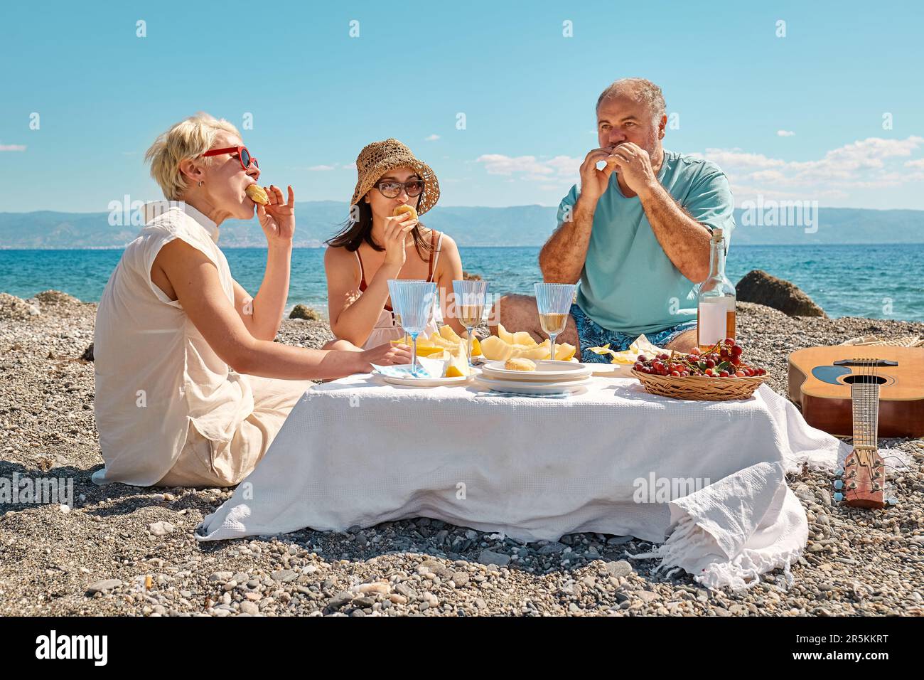 Summer beach picnic. Group of middle aged friends having picnic with ...
