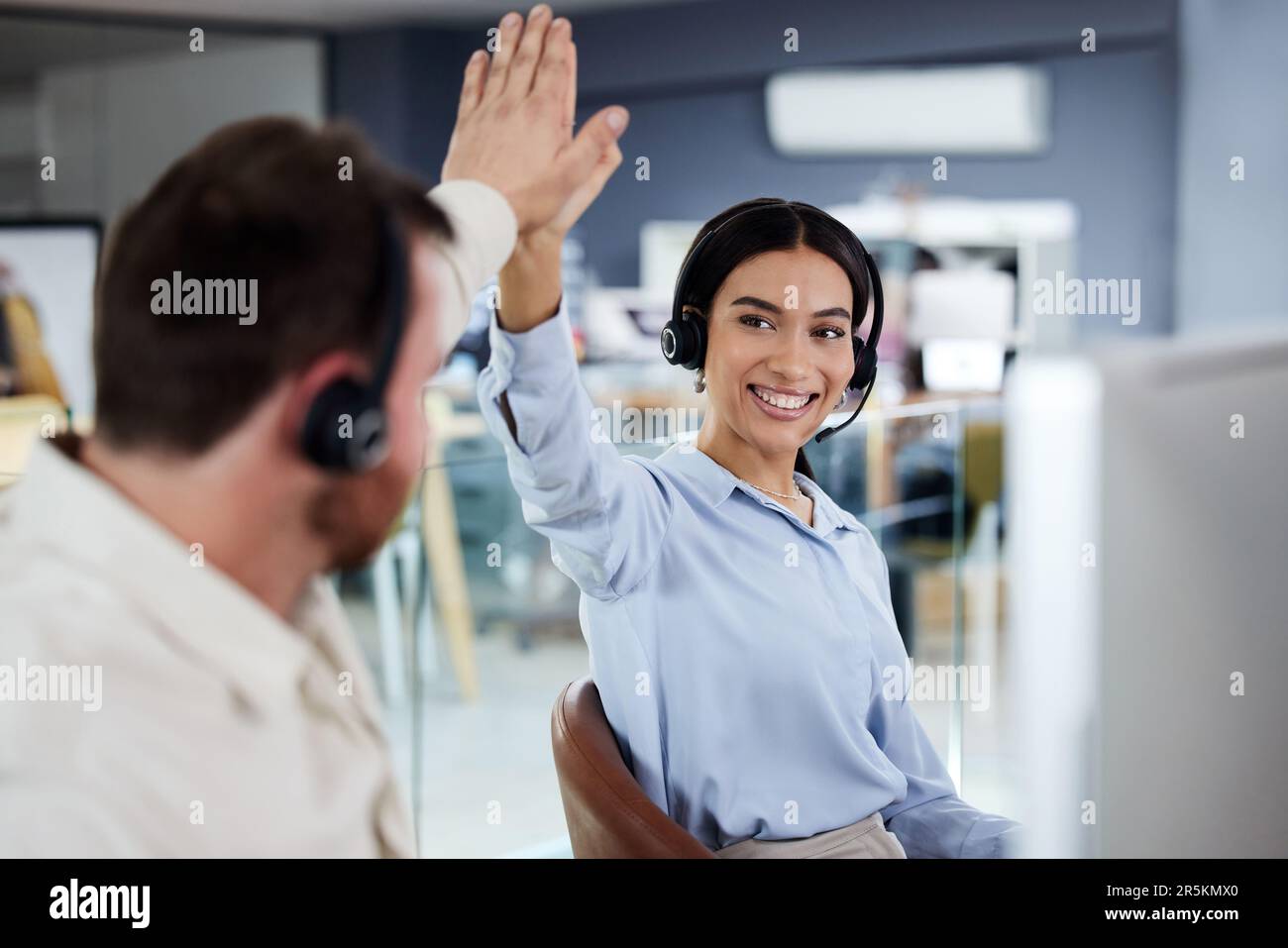 Success, colleagues with celebration and high five at their desk in a ...