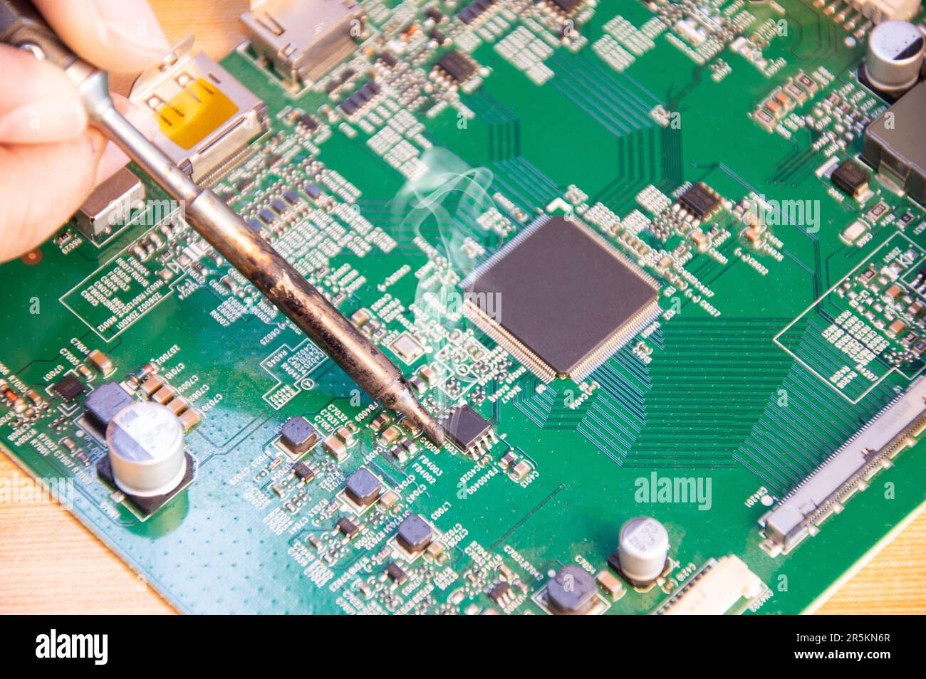 top view, mechanic repairing motherboard, soldering Stock Photo - Alamy