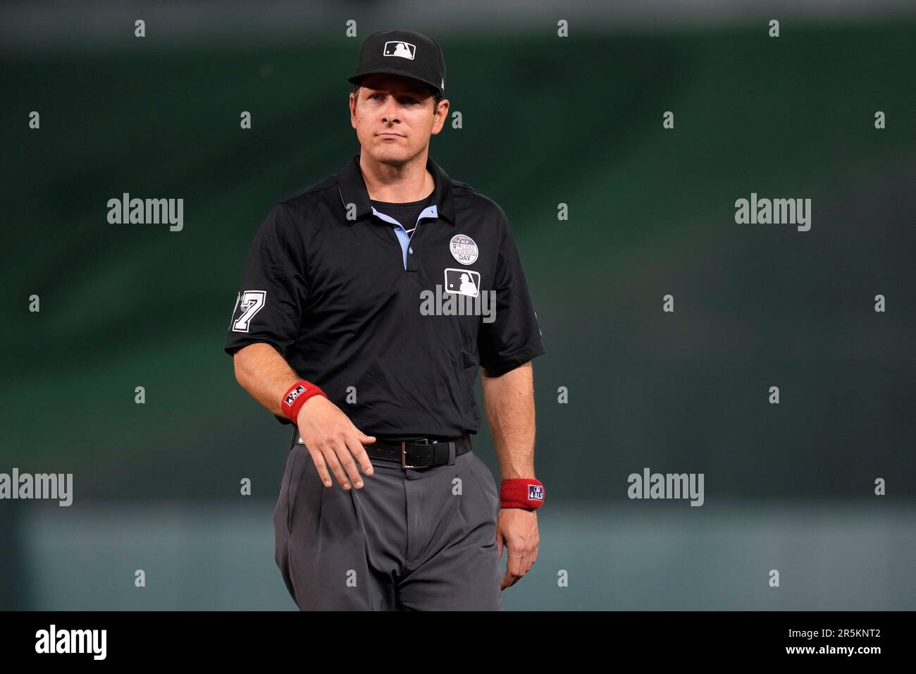 Umpire Ben May walks on the field during a baseball game between the ...
