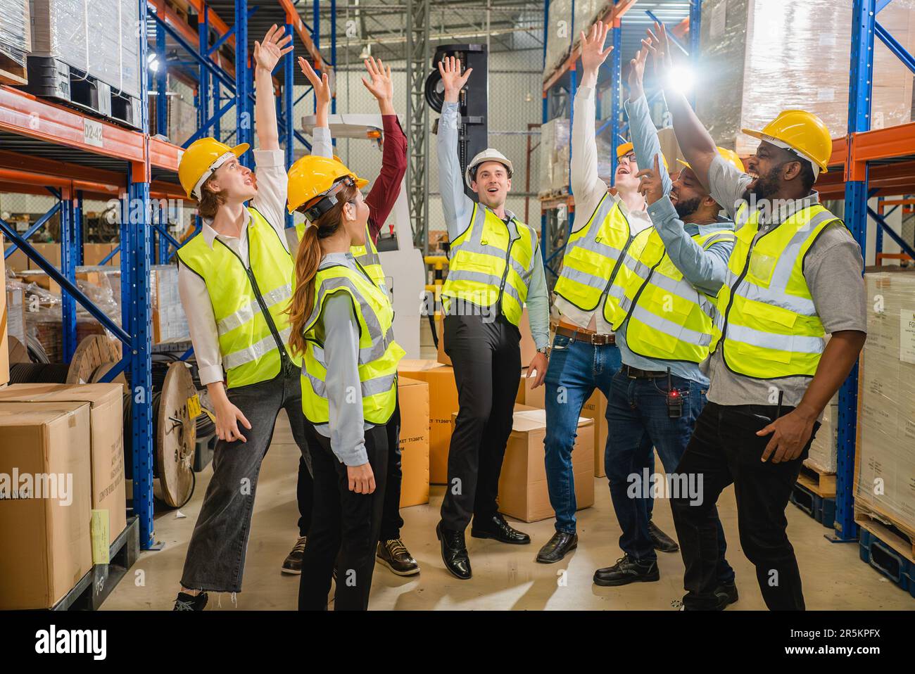 Group of happy warehouse workers celebrating success in warehouse Stock Photo - Alamy