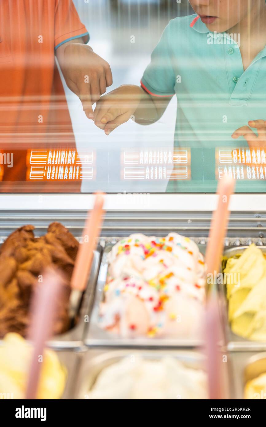 Two children choosing an ice cream flavor in an ice cream shop Stock ...