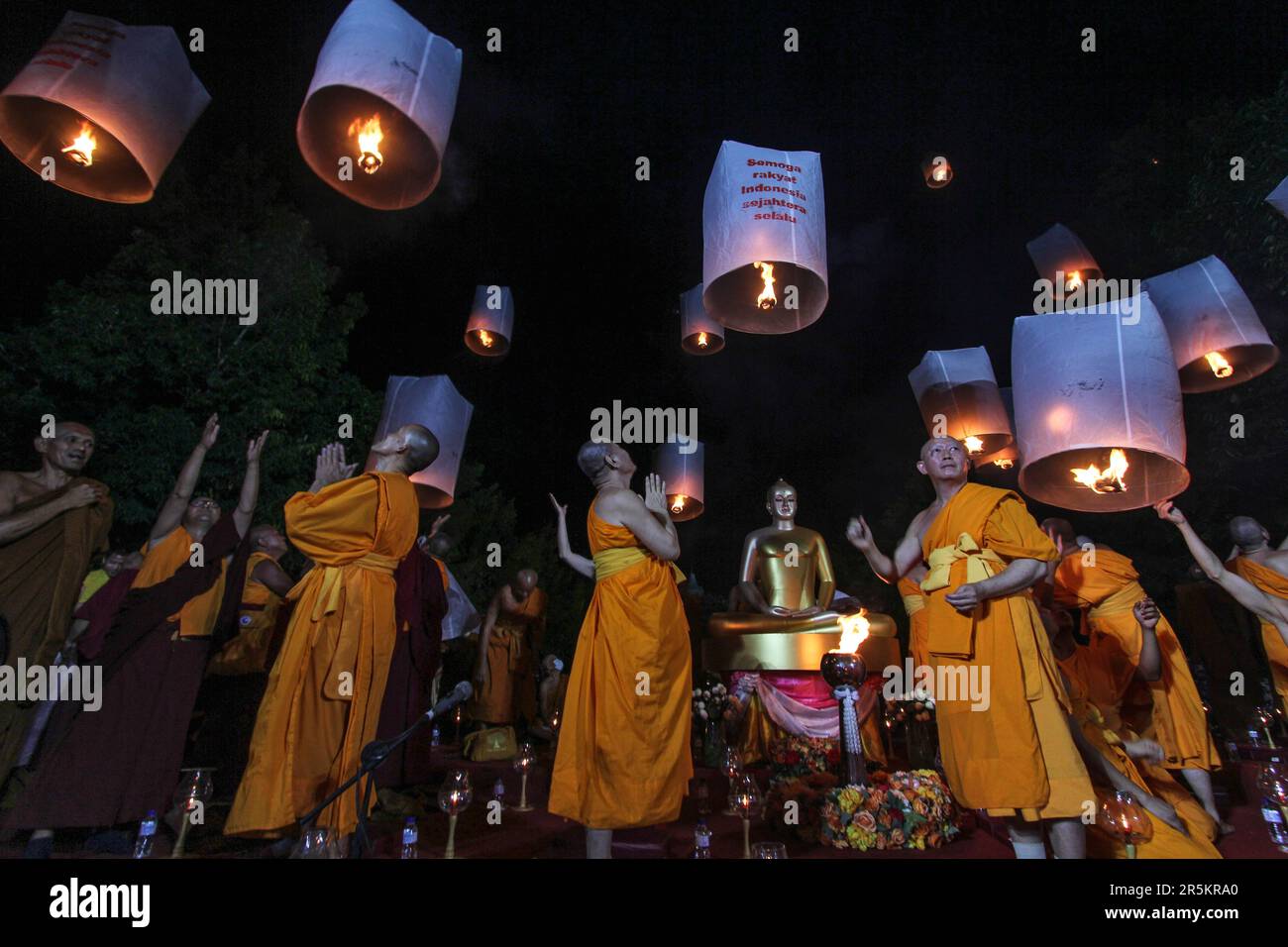 Buddhist monks release lanterns during a Vesak Day procession at Borobudur Temple compound in ...