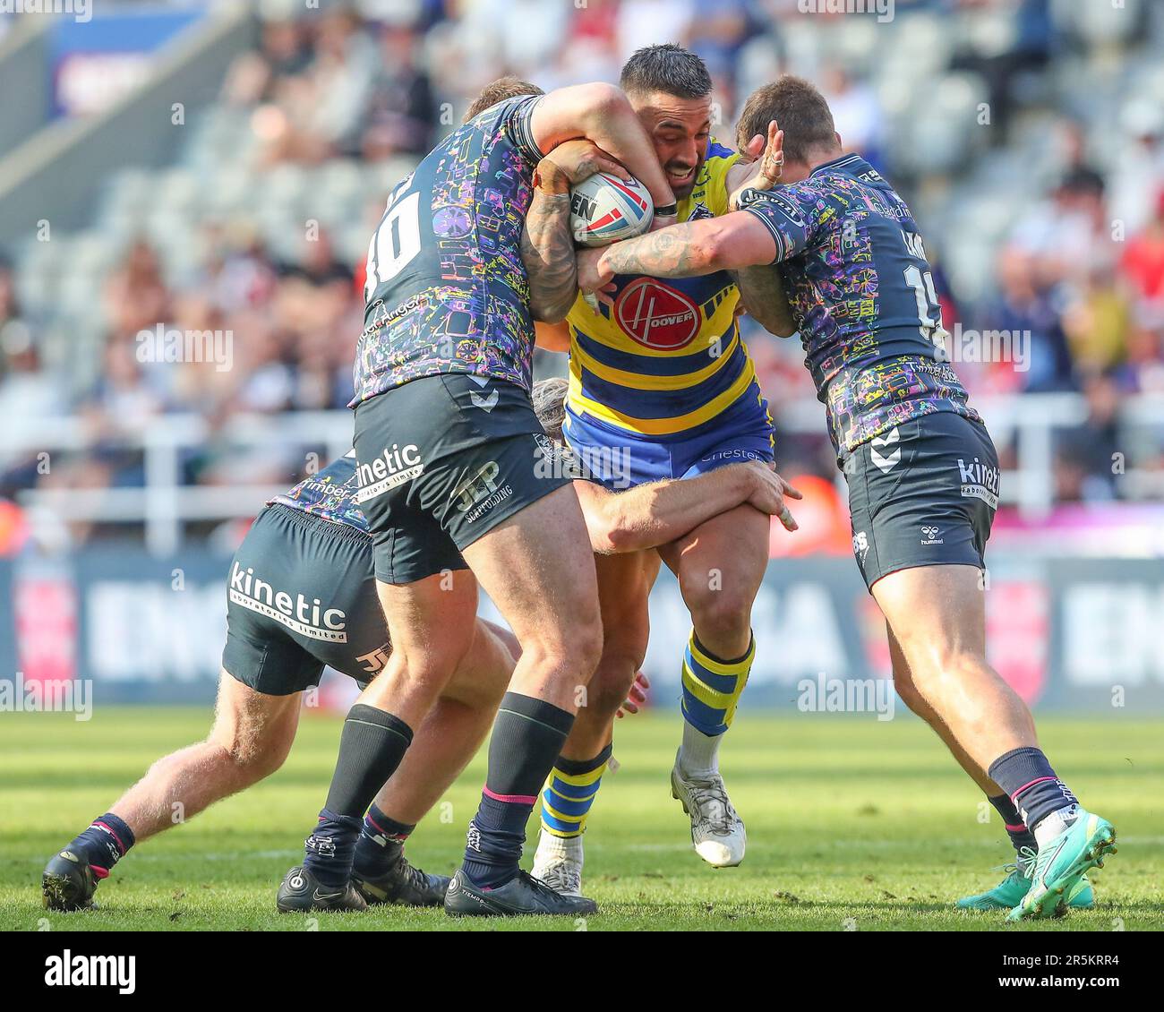 Paul Vaughan #10 of Warrington Wolves is tackled during the Magic ...