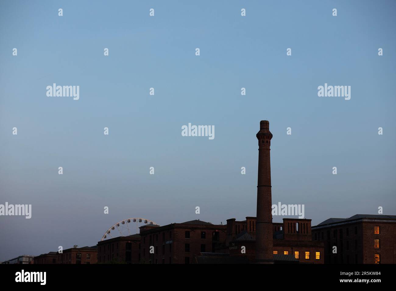 Silhouette of buildings, the Pumphouse pub brick chimney, and Wheel of ...