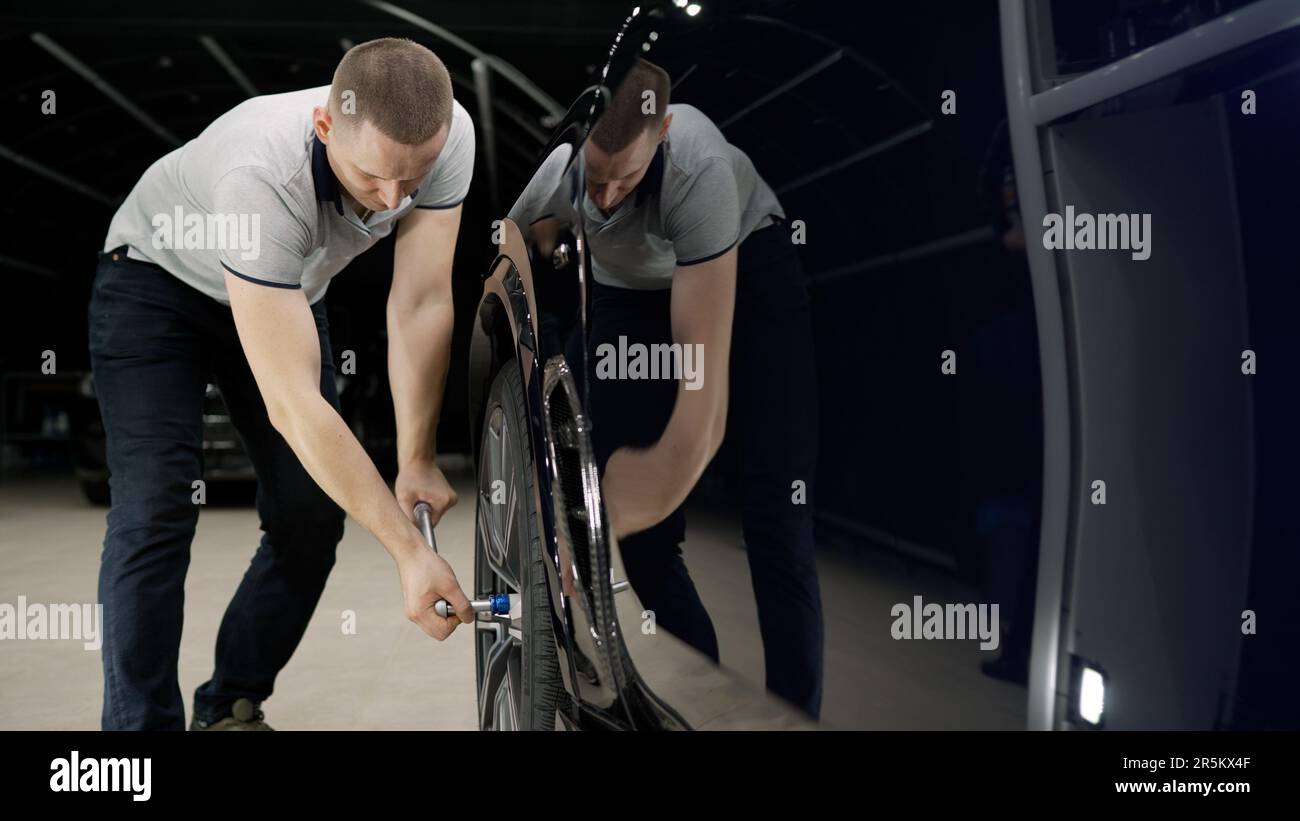 Car wheel replacement in workshop, self service tire fitting concept ...