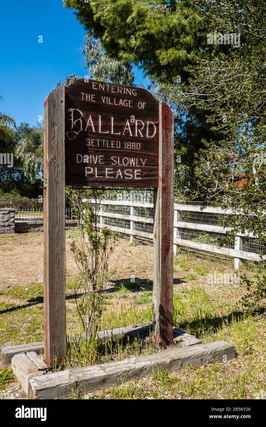 A wooden carved sign, at the village limits, for the village of Ballard ...