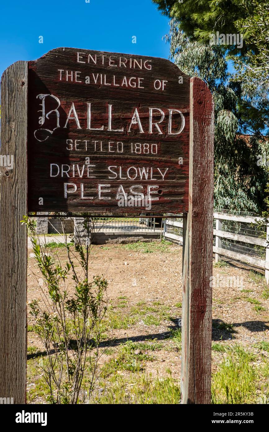 A wooden carved sign, at the village limits, for the village of Ballard ...