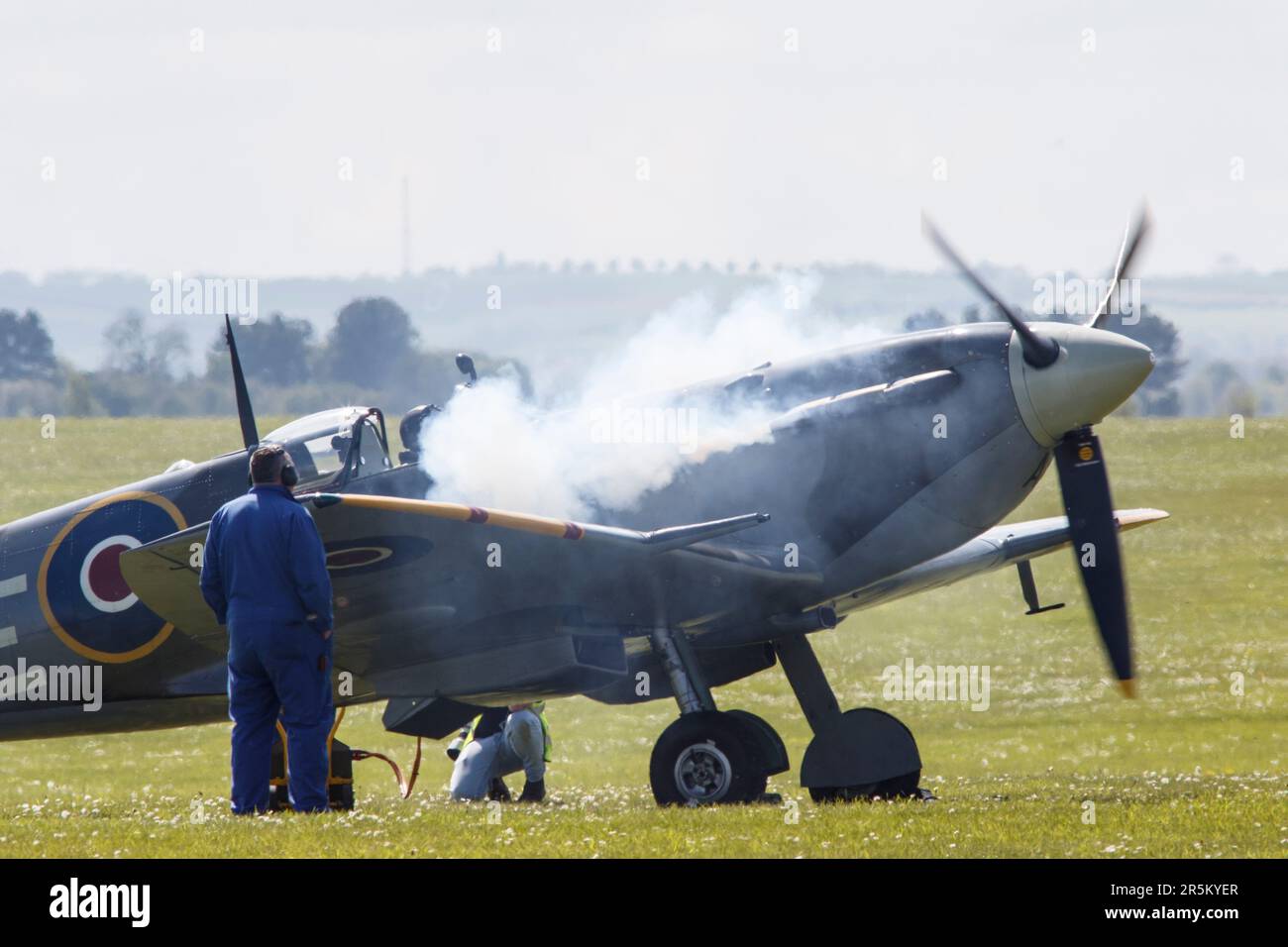 A spitfire engine smokes on start up at RAF Duxford for as airshow in ...