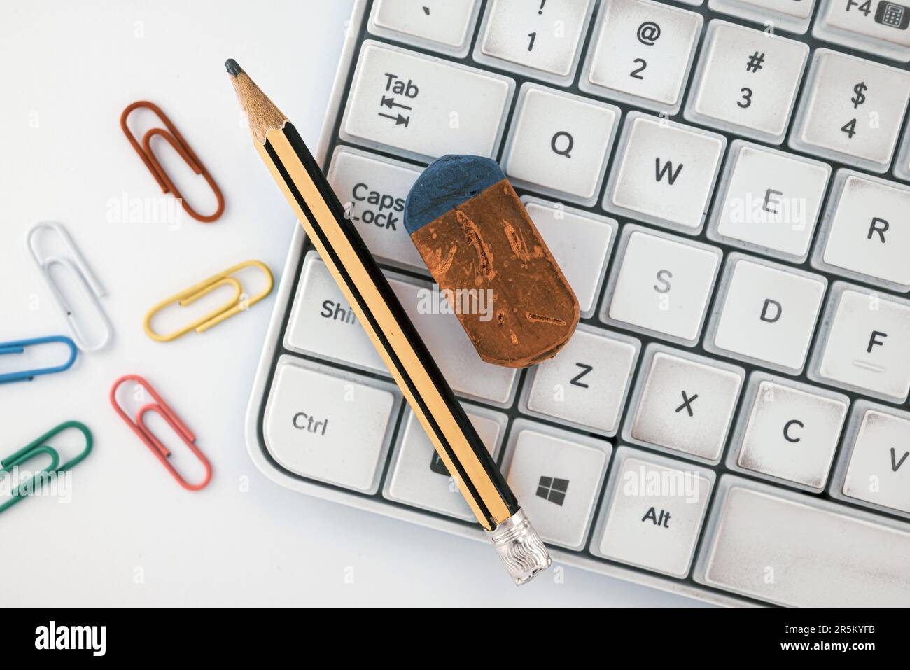 Keyboard with pencil, eraser and staples Stock Photo - Alamy