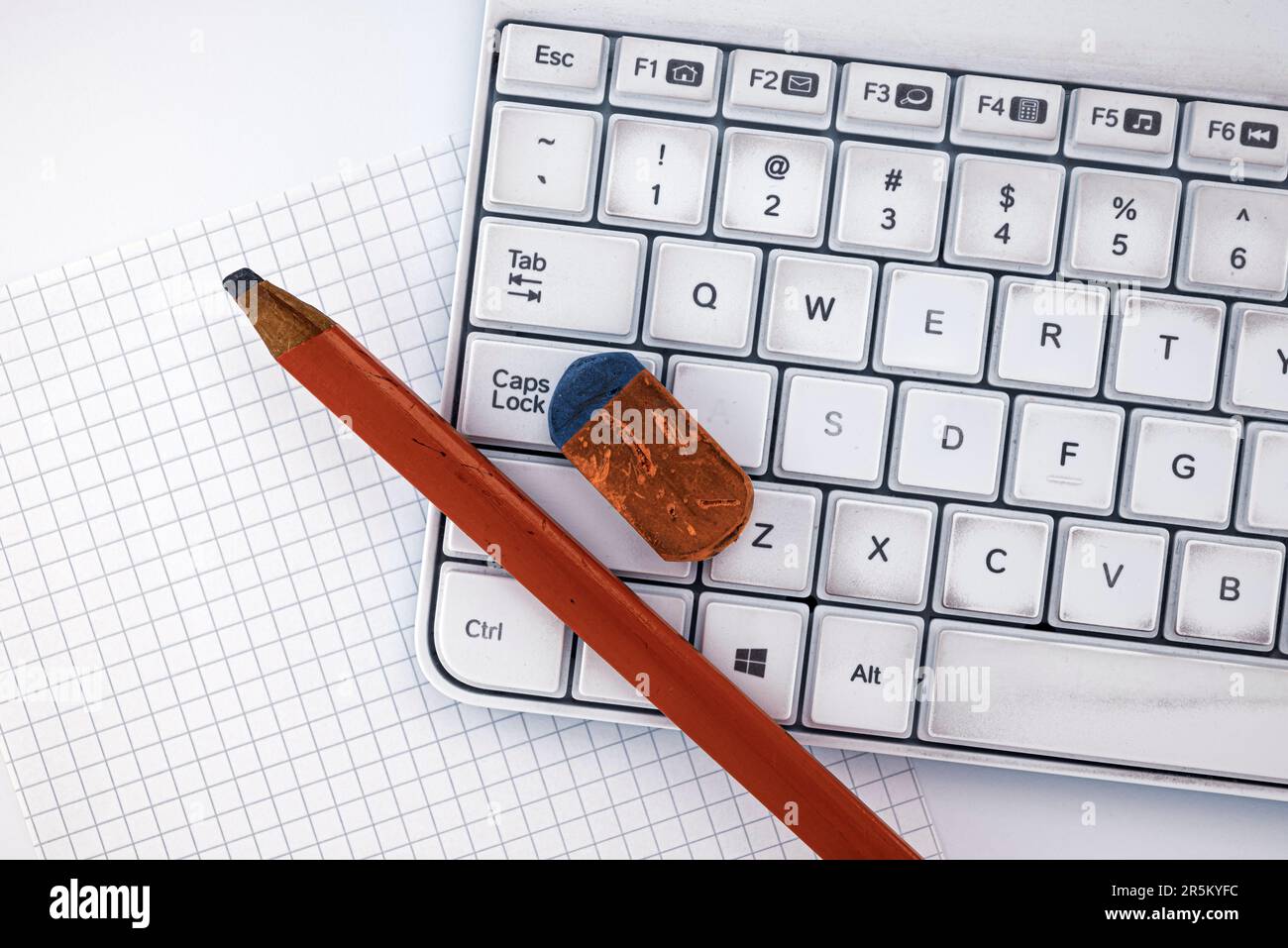 Keyboard with pen and eraser on work paper Stock Photo - Alamy