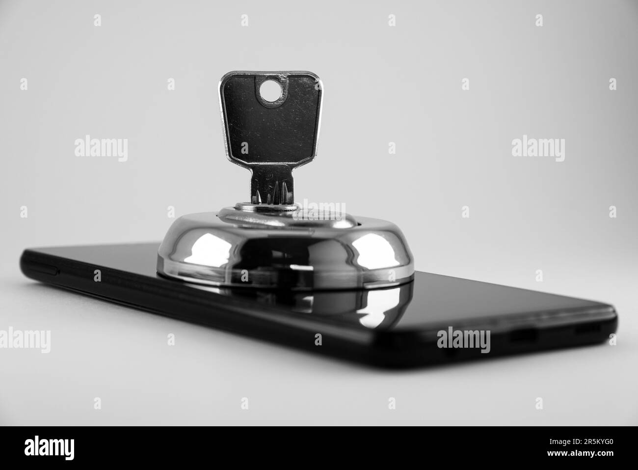 Smartphone phone locked with the real key and lock Stock Photo - Alamy