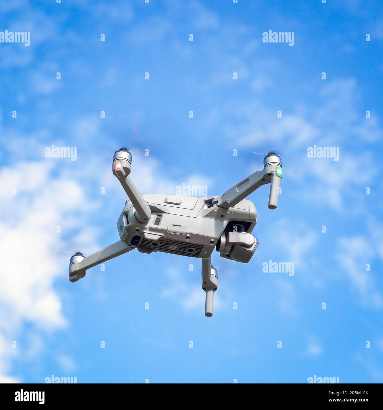 drone DJI air 2S in the sky, side view, close-up, blue sky with clouds ...
