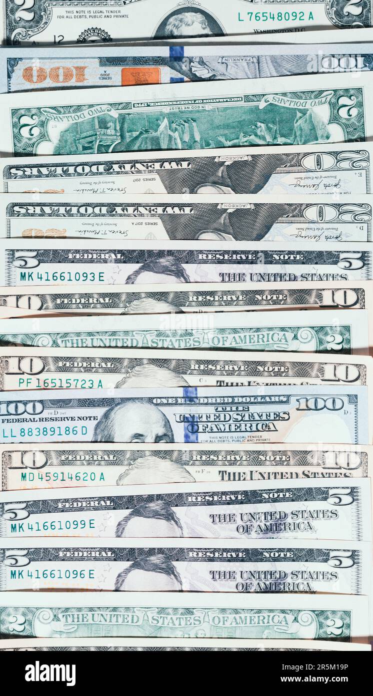 vertical background of spread out paper US dollars of different ...