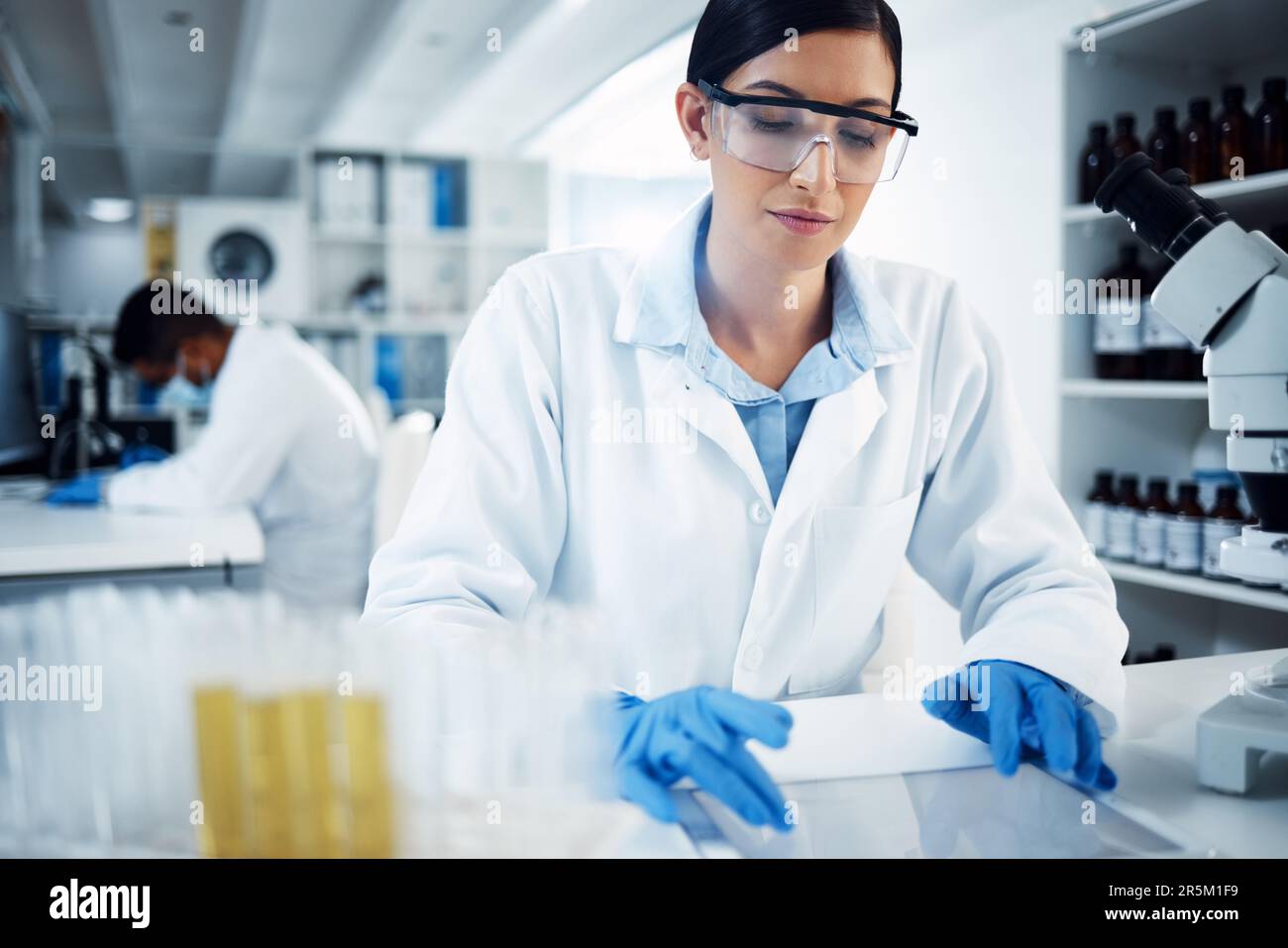 Science, research and woman on tablet in laboratory for medical ...