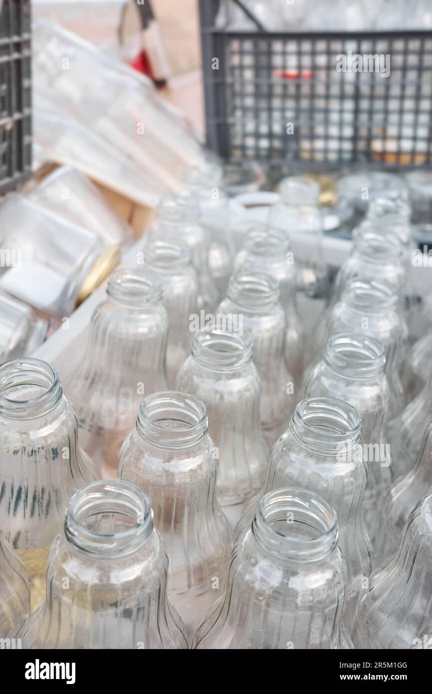 Used empty glass bottles stored in containers for recycling, selective ...