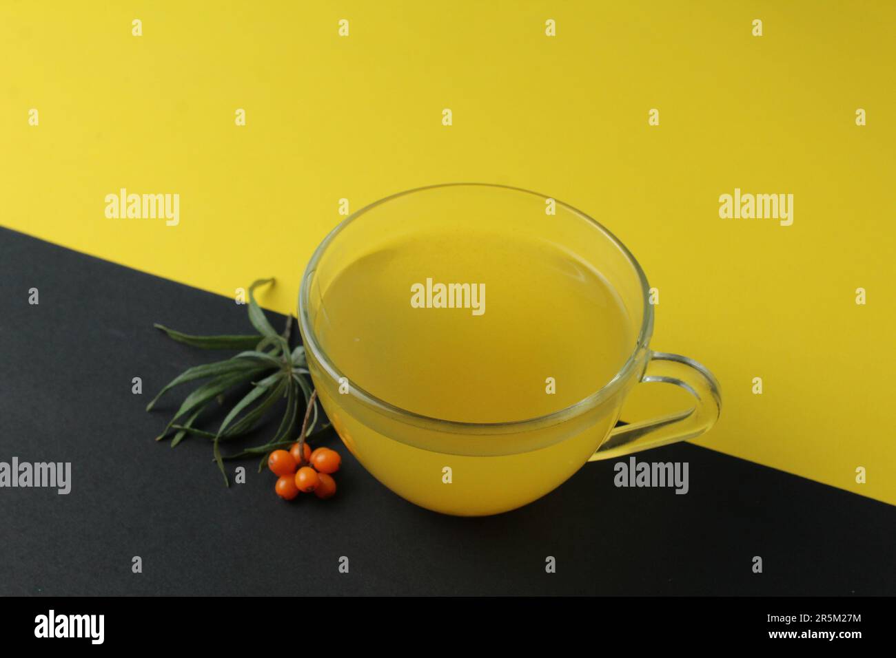 sea buckthorn tea drink on a black yellow bright background. Sea ...