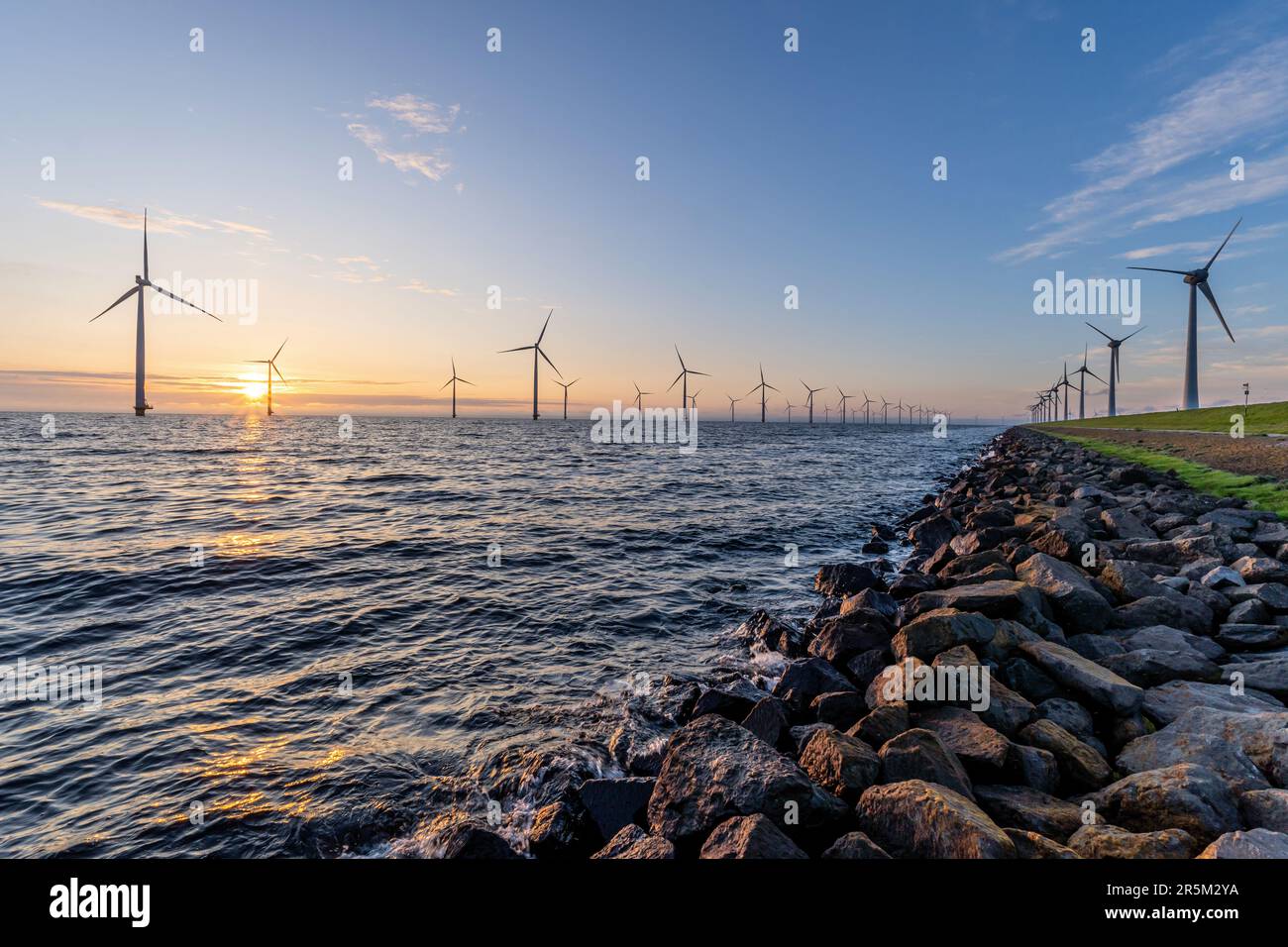 onshore and offshore wind farm at sunset Stock Photo - Alamy
