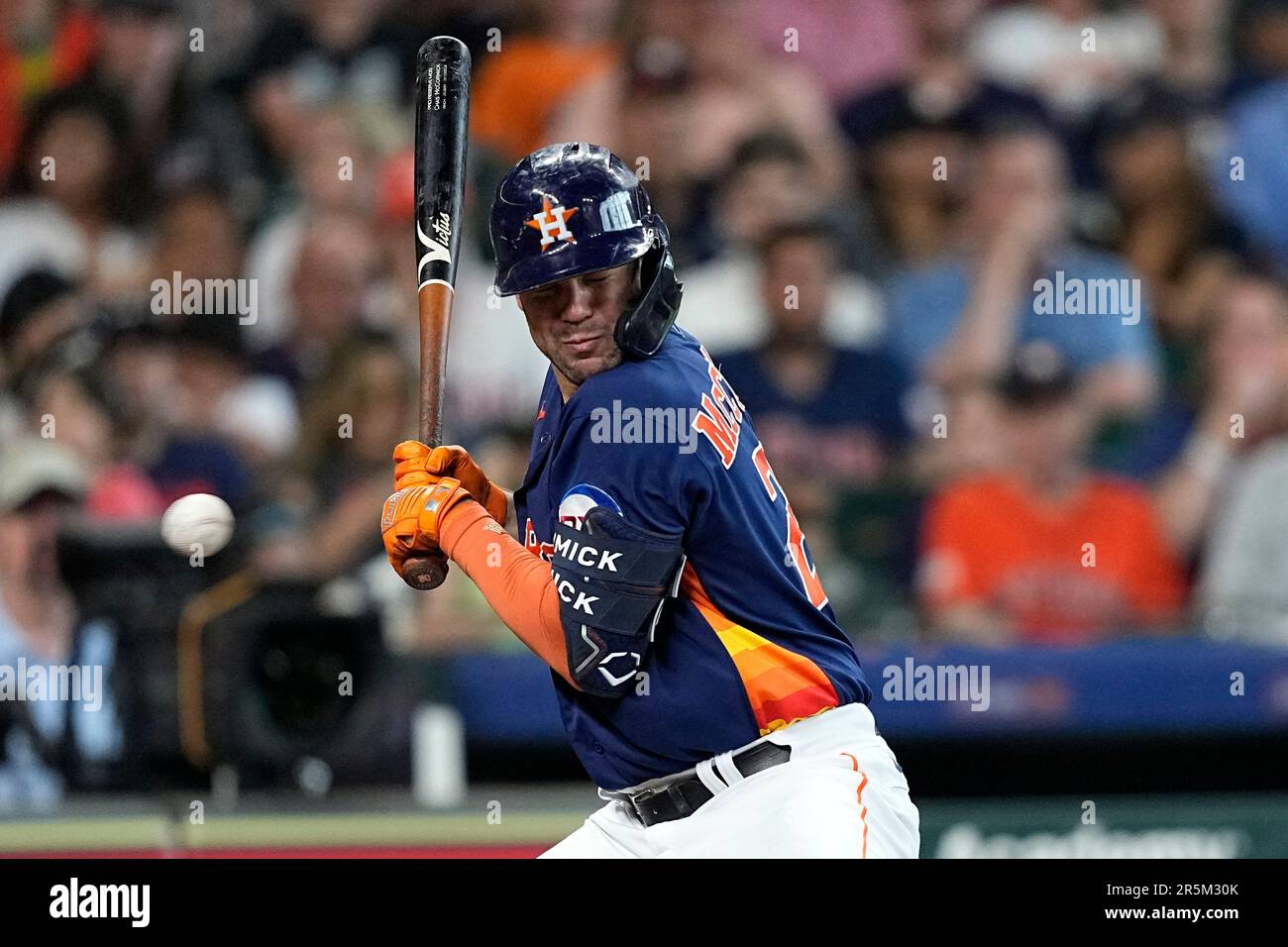 Houston Astros' Chas McCormick reacts after being hit by a pitch thrown by Los Angeles Angels ...