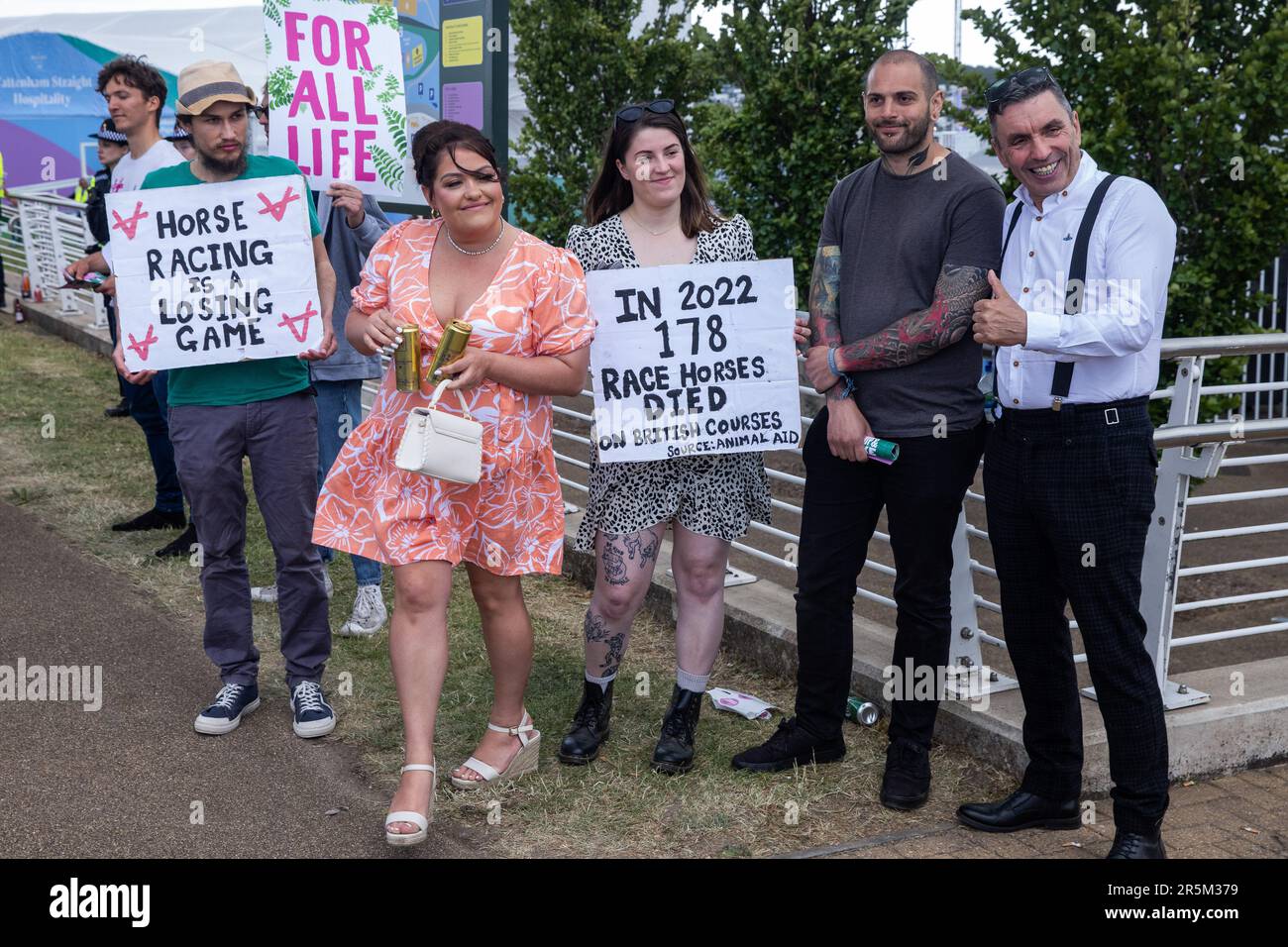 Epsom, 3rd June, 2023. Racegoers pose with animal rights activists ...