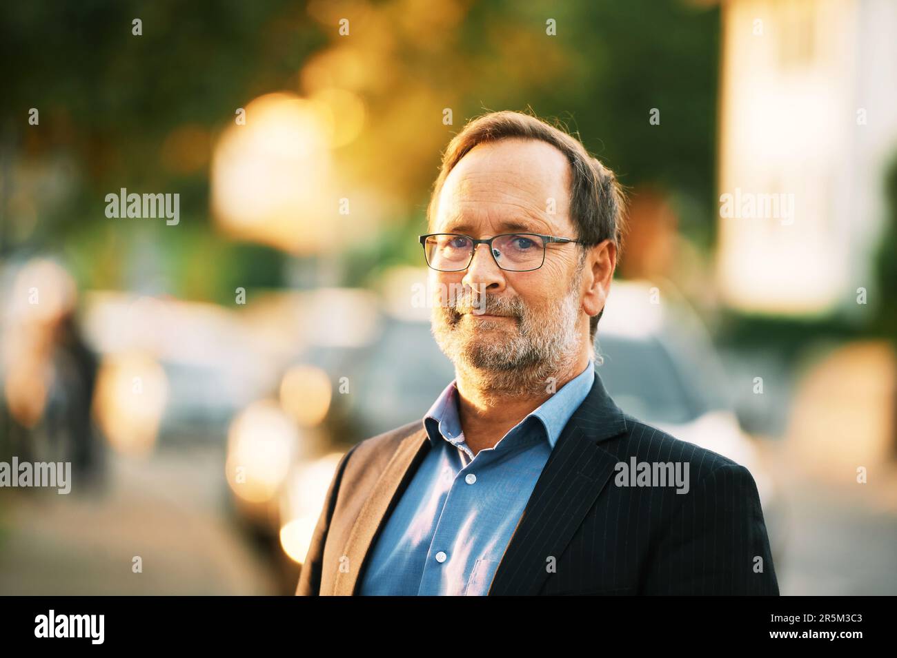 Outdoor portrait of middle age man wearing suit and glasses Stock Photo ...