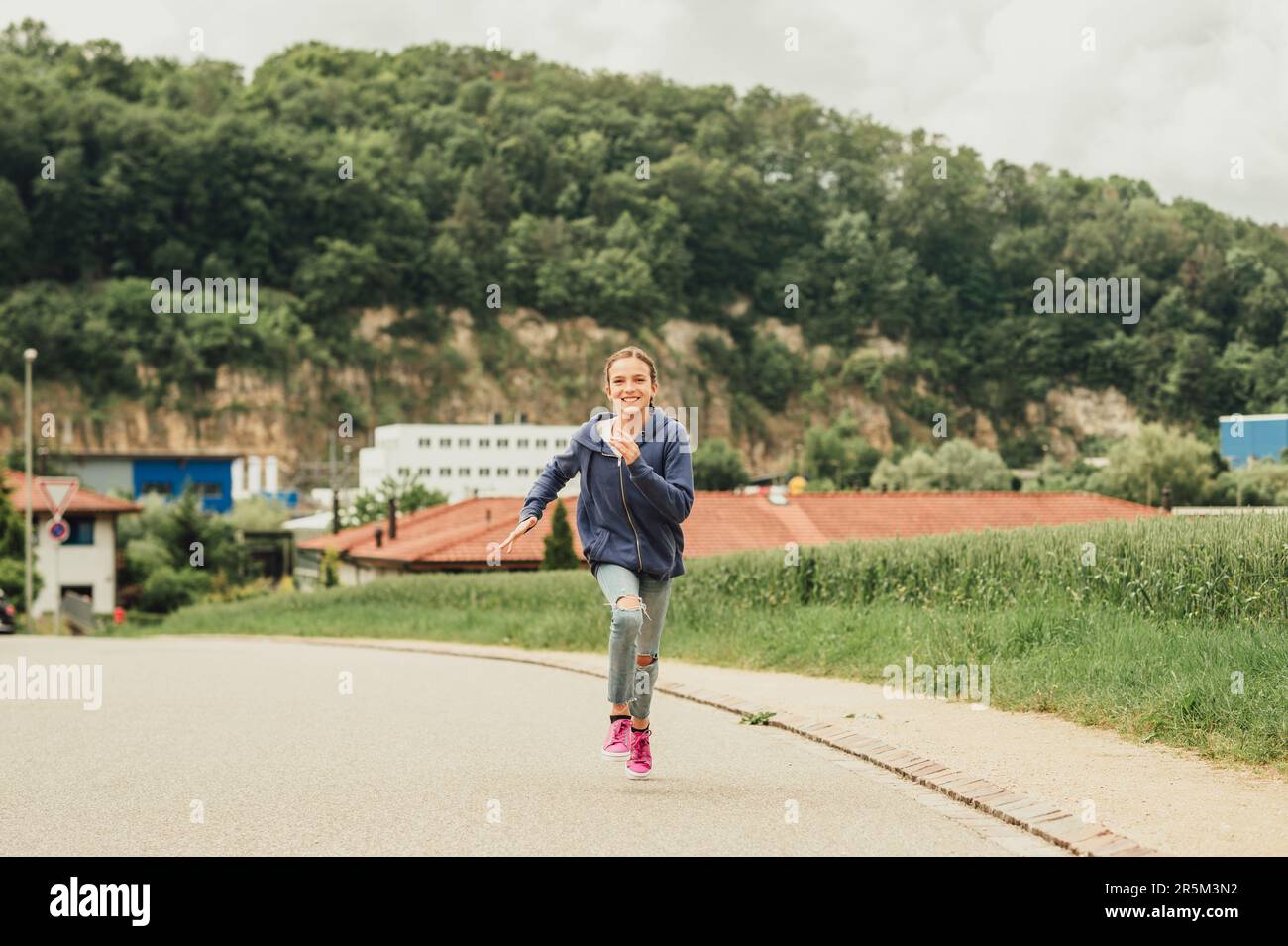 Kid girl running up the road, sporty child hurrying up fast Stock Photo ...