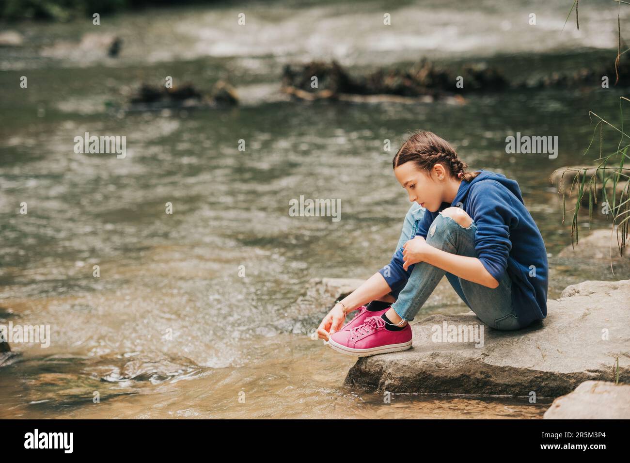Happy young girl resting by river, child and nature, summer camp for ...