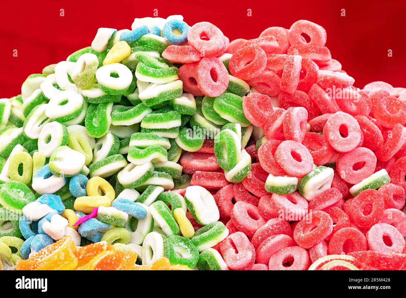 Colorful foam gummy sweets pile sold on market fair Stock Photo - Alamy