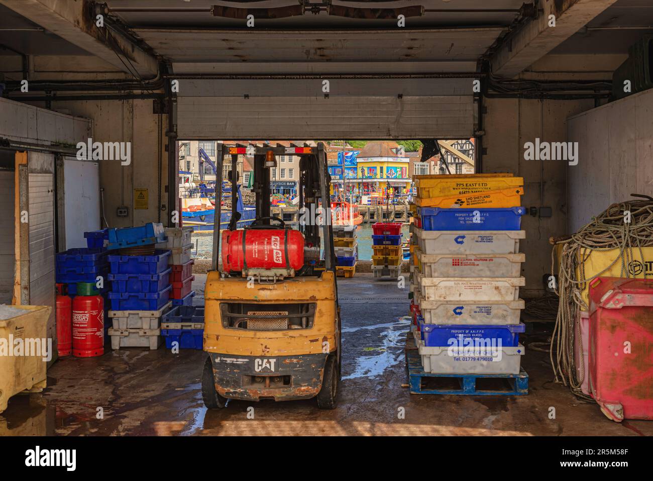 The inside of a fish storage unit. Containers are stacked and fork-lift ...