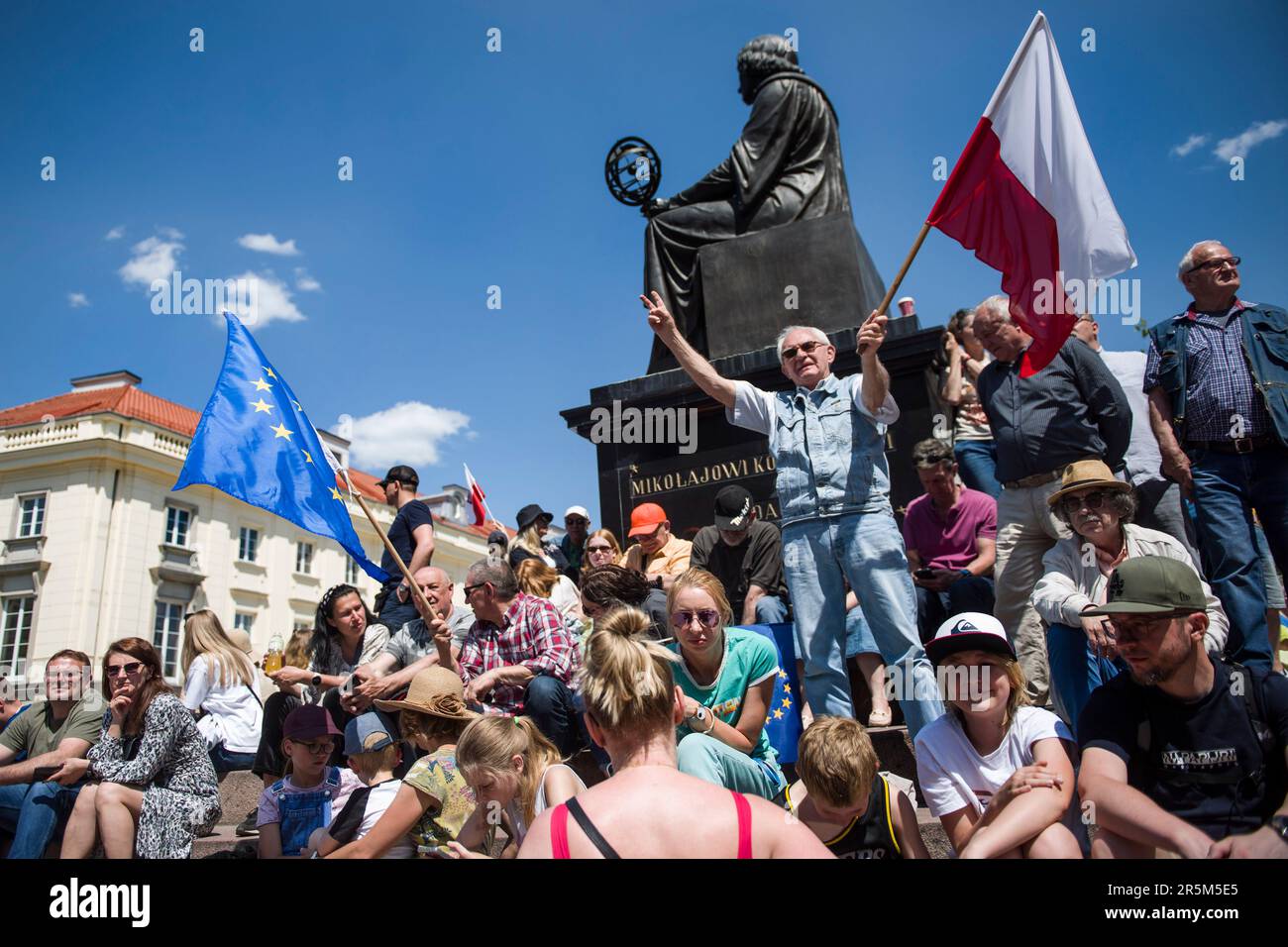 Participants are seen holding placards and waving Polish flags during ...