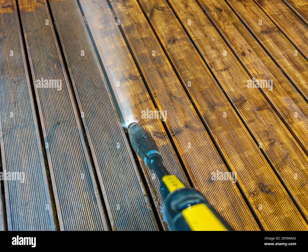 Cleaning wooden terrace decking before oiling and painting with a high ...