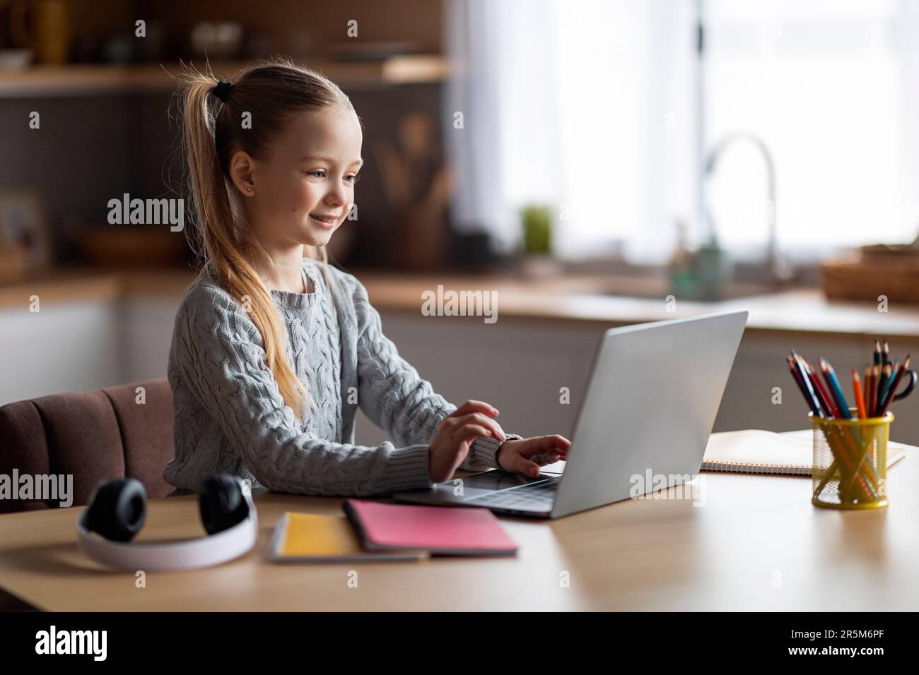 Coding For Kids. Cute Little Girl Using Laptop At Home Stock Photo - Alamy