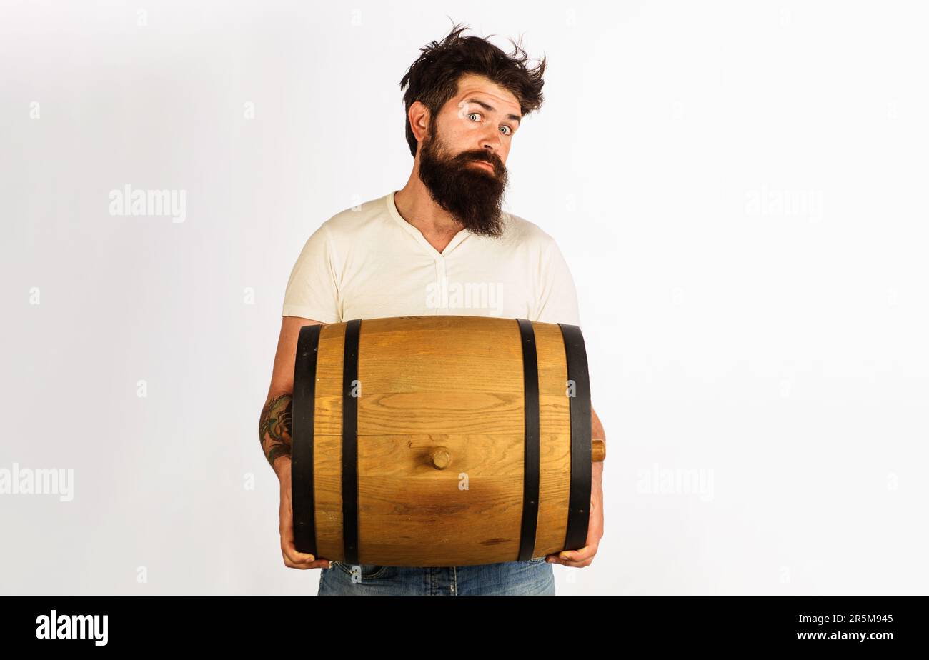 Homemade wine. Bearded man with wooden barrel wine or beer ...