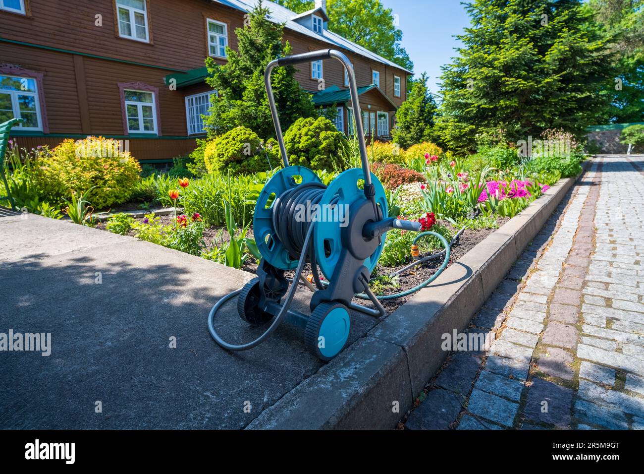 Watering garden hose wound on a reel. A compact, easy-to-use hose for ...