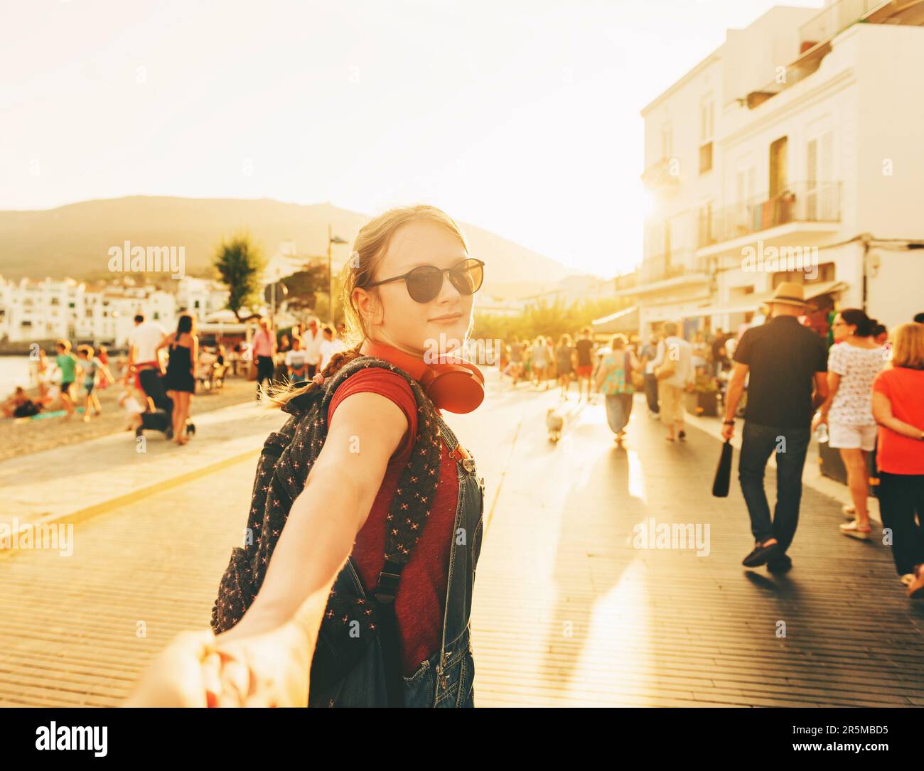 Follow me portrait of pretty teenage girl walking down the road ...