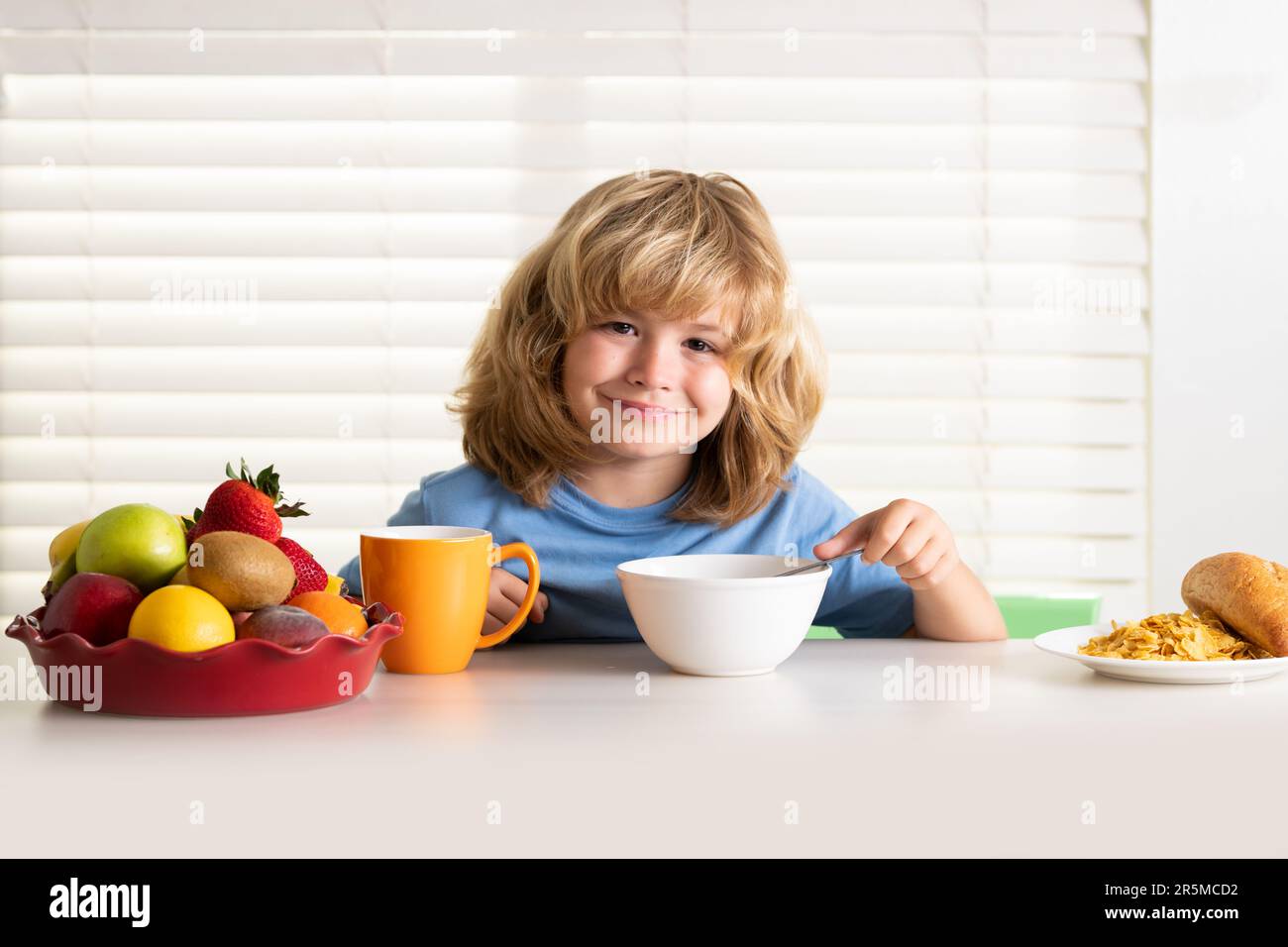 Little child boy having healthy breakfast. Kids nutrition and ...