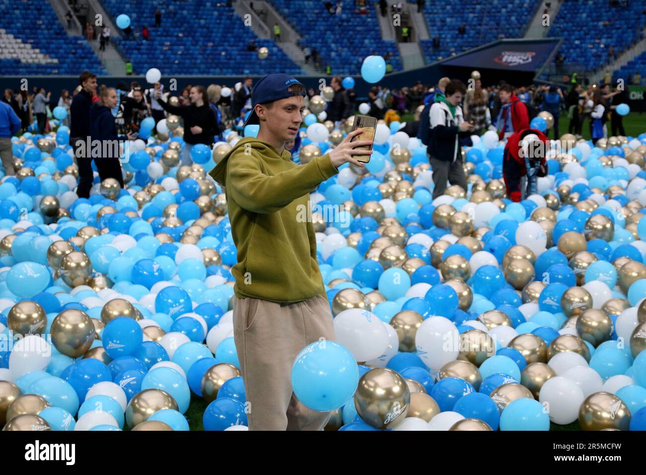 Fans of the Zenit football club run through balloons. Zenit football ...