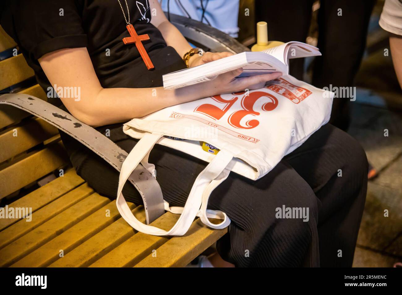 Hong Kong, China. 04th June, 2023. A woman reads "May 35th" on a bench ...