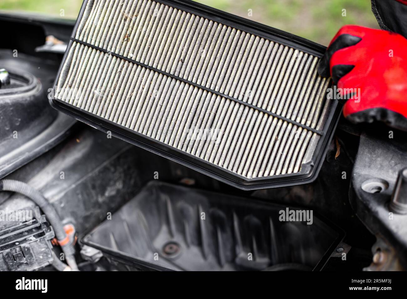 The mechanic removed the internal combustion engine air filter from the ...