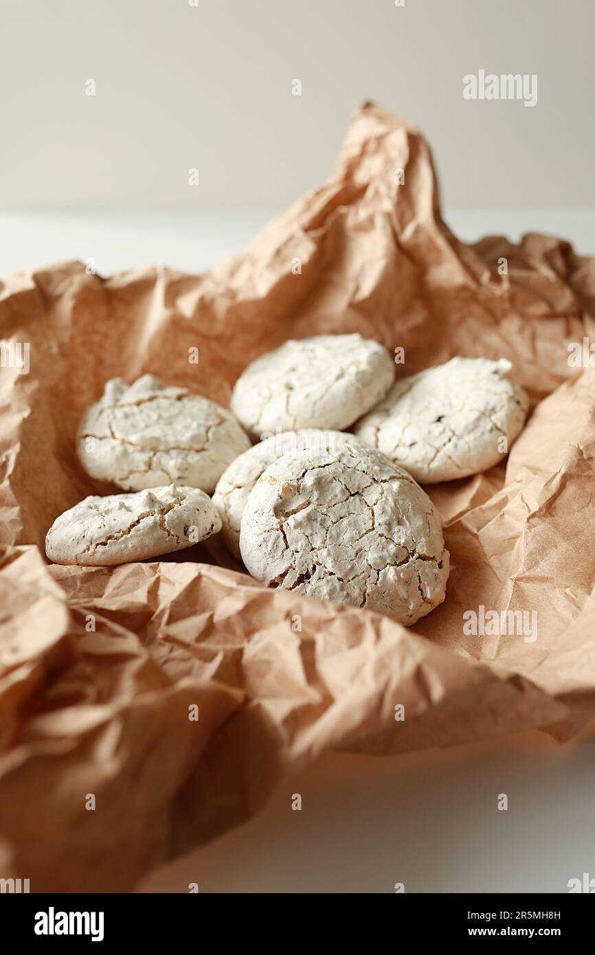 French fragile beige meringue cookies with cracks served on a brown ...