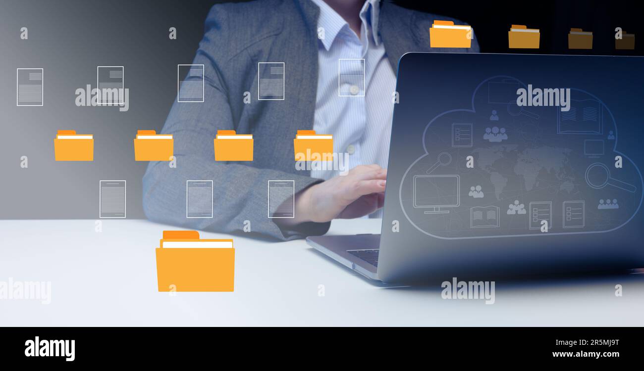 Woman sits at a table and works with a laptop. Document management ...