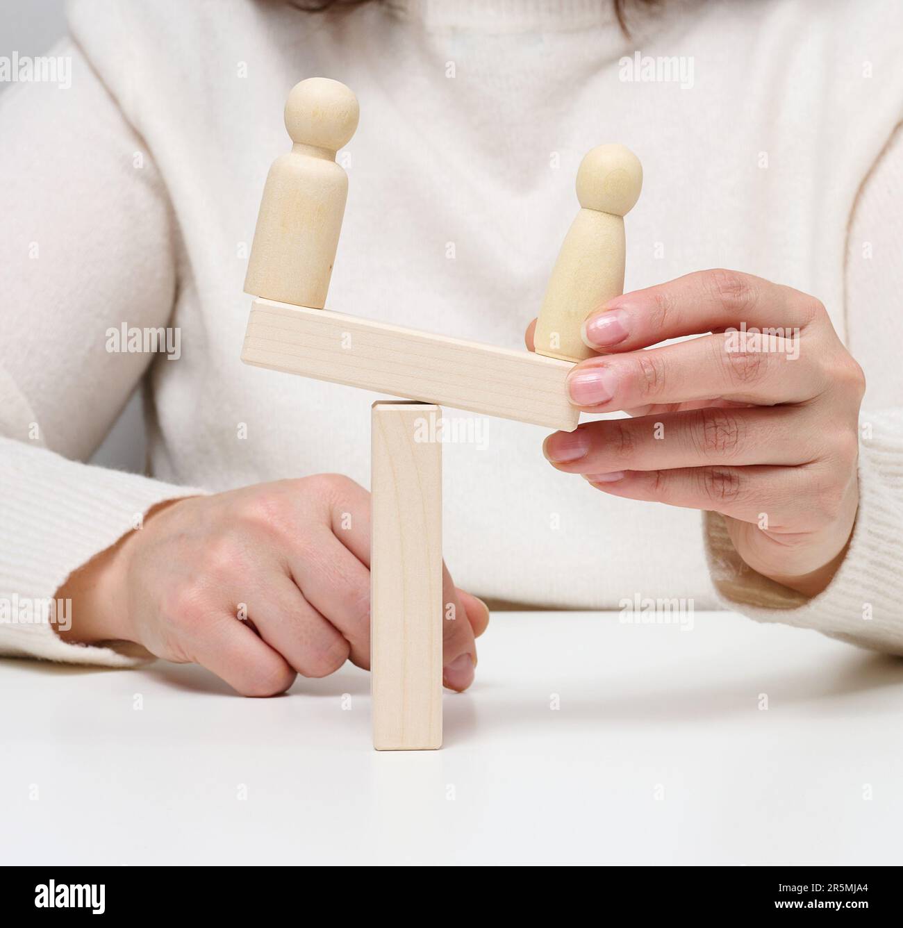 Two wooden figurines of a man stand opposite each other, concept of ...